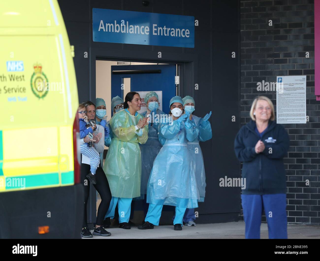 NHS staff gather in a doorway at the Aintree University Hospital in ...