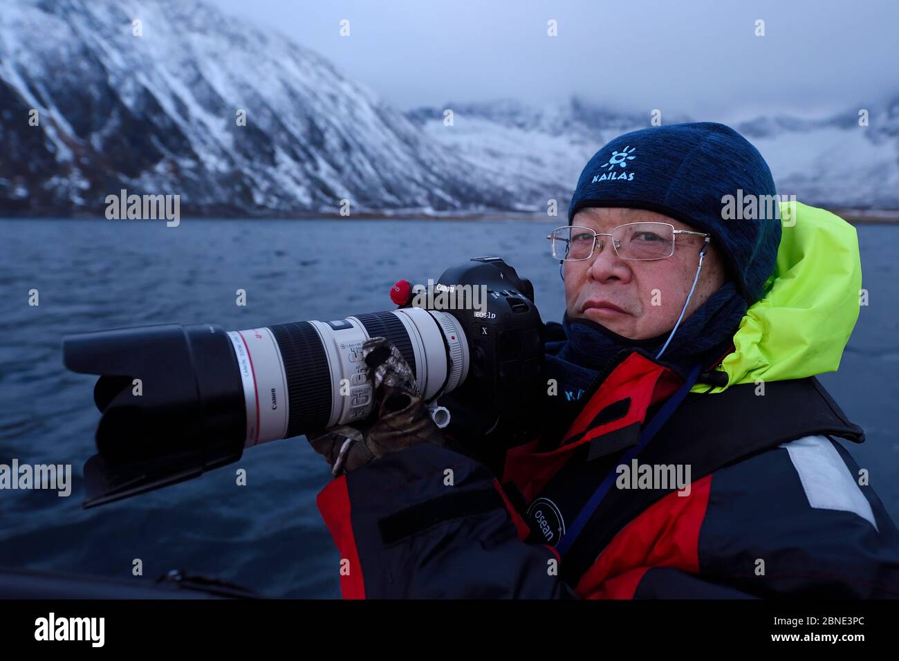 Whale watcher with camera, near Senja, Troms County, Norway ...