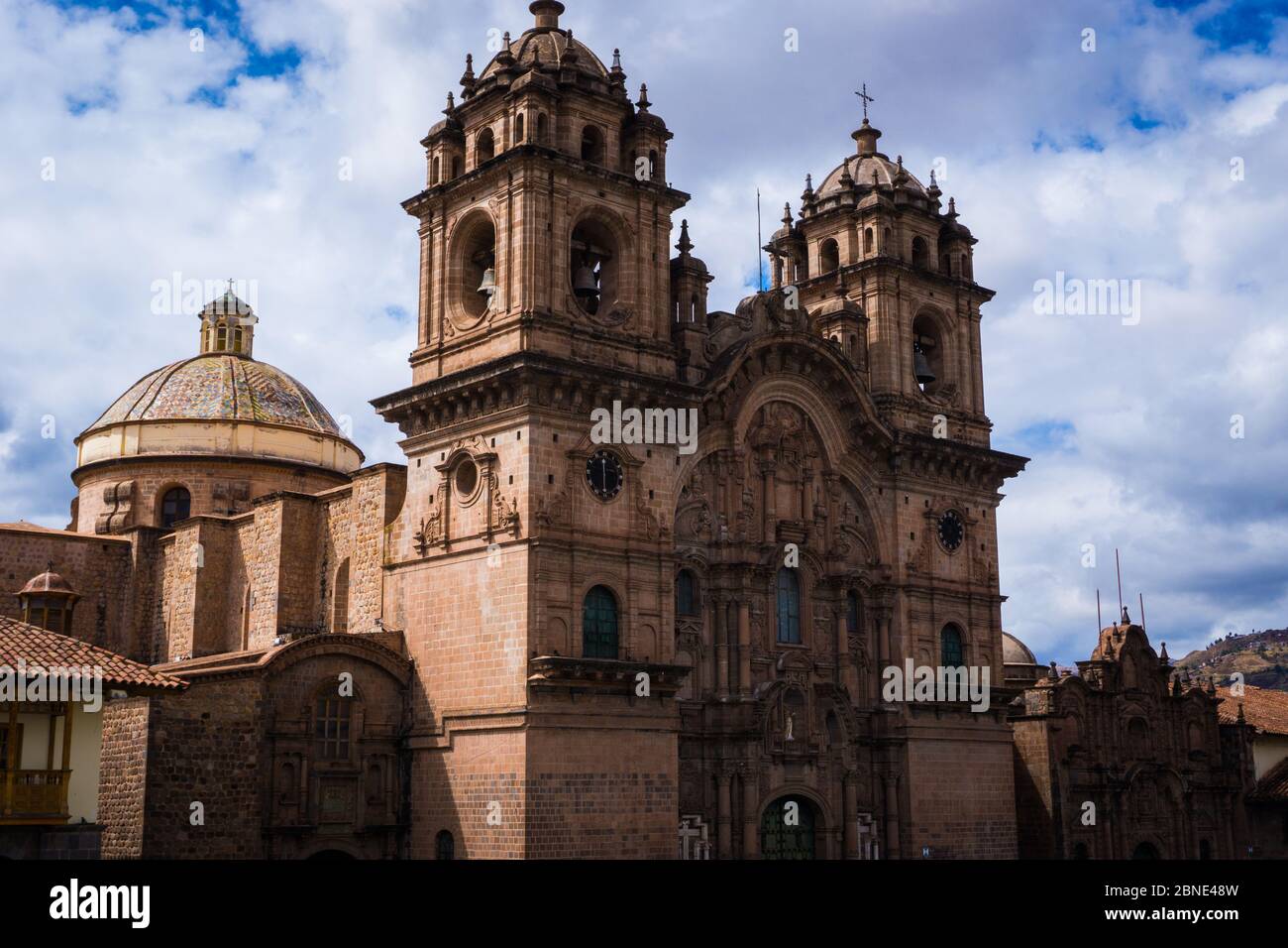 Facade with the towers of the entrance of a stone ancient church. Jesus ...