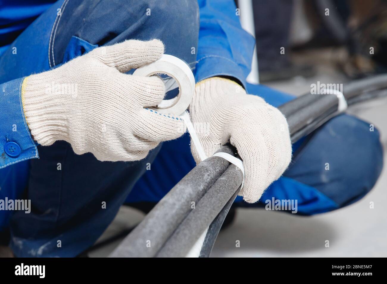 Worker man Installation of pipe channel for connecting air conditioner ...