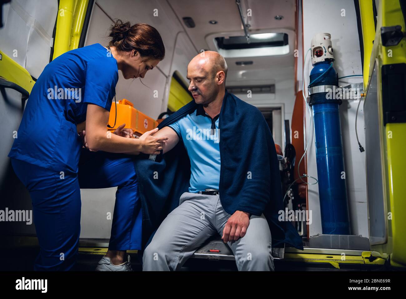 Paramedics providing first aid victim hi-res stock photography and ...