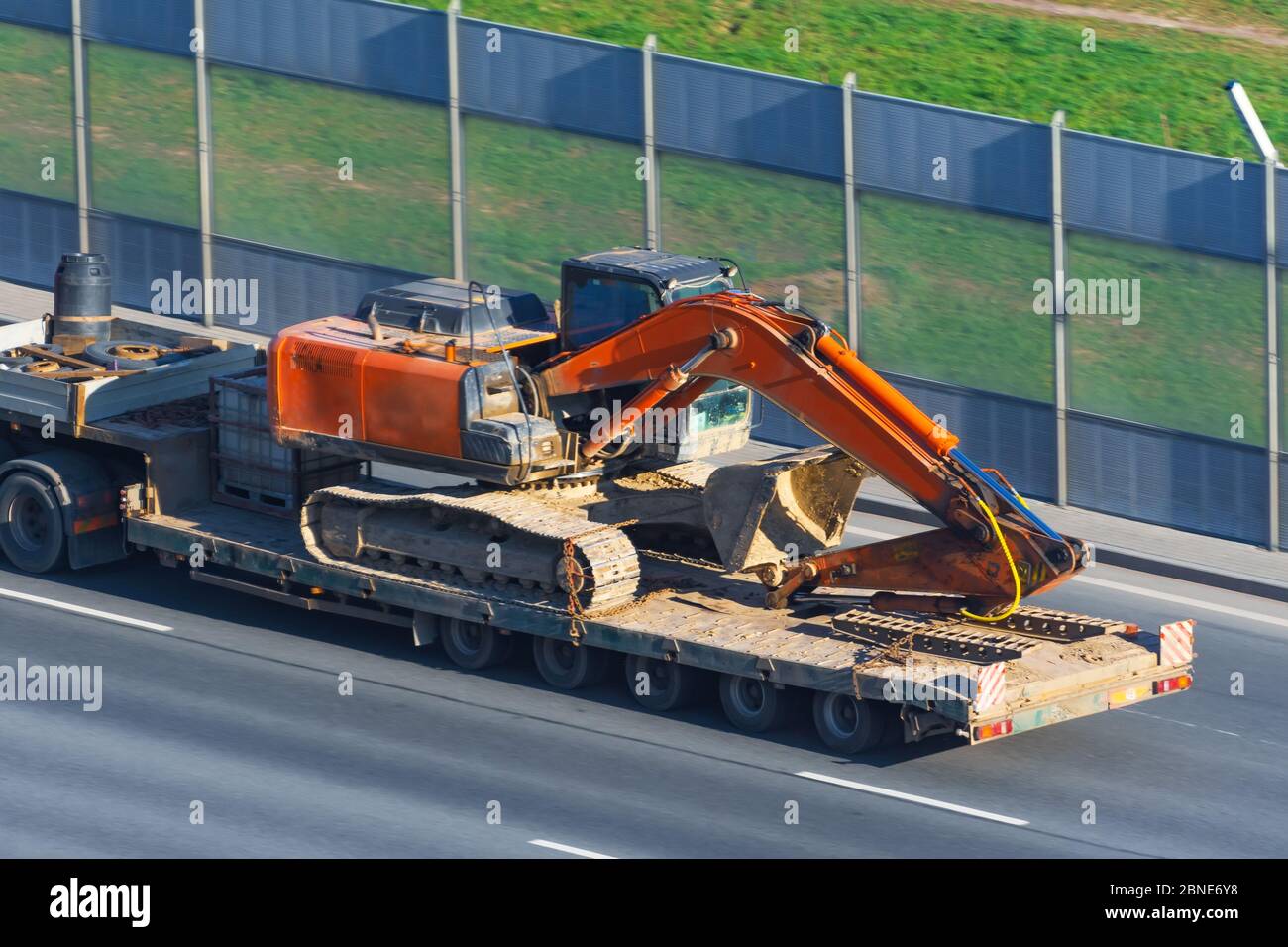 Heavy excavator on transportation truck with long trailer platform on ...