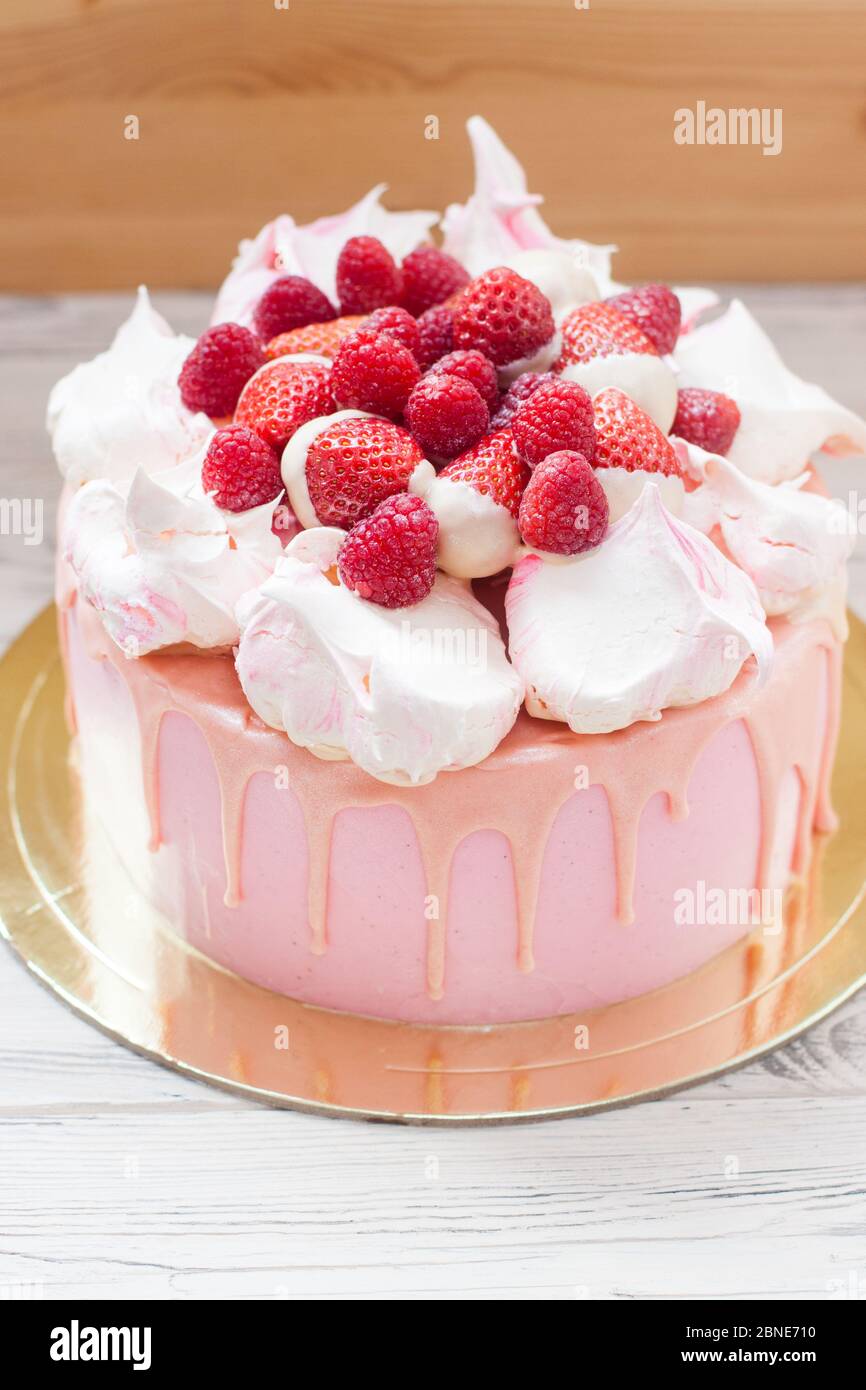 Pink cheese cake with melted chocolate, meringues, fresh raspberries ...