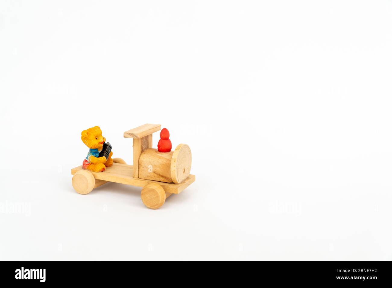 Wooden train on a white background. Wooden toy yellow locomotive with a ...