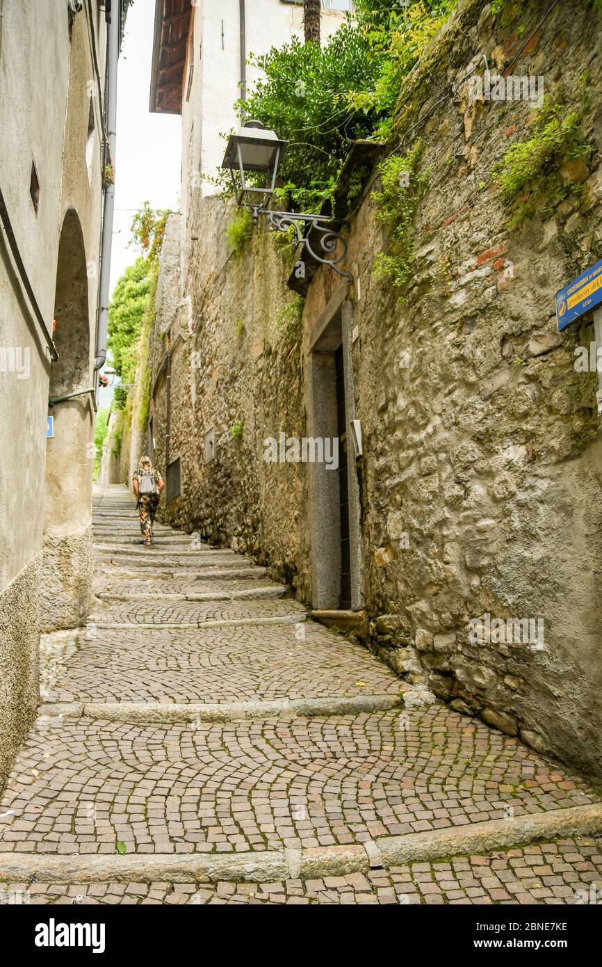 LAKE COMO, ITALY - JUNE 2019: Person walking up cobbled steps on the ...