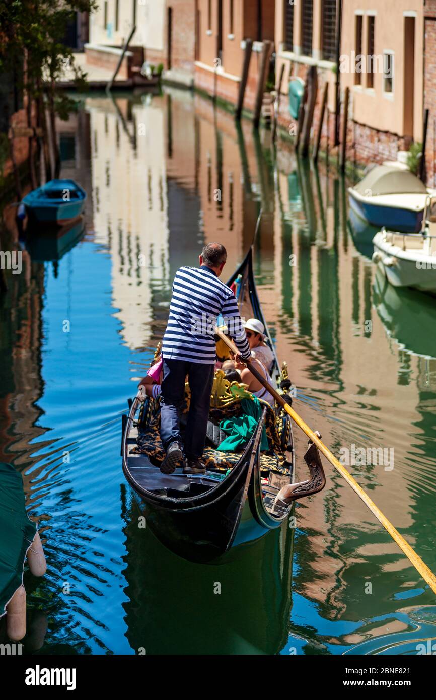 Tourist view of Venice. Channels with reflections. Street lights and ...