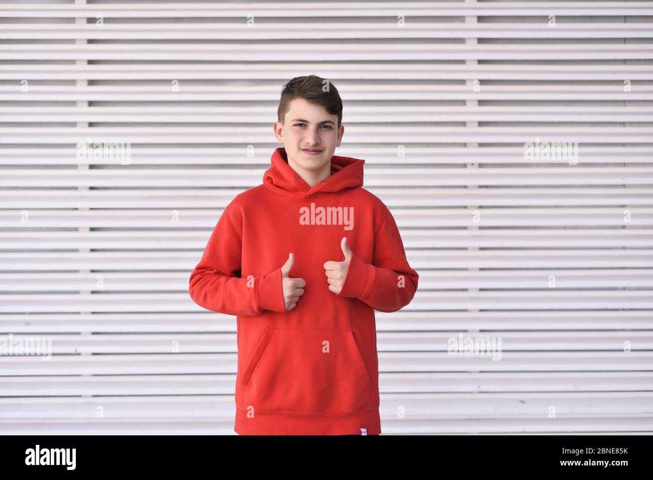portrait of smiley teenager. dressing in a red shirt Stock Photo - Alamy