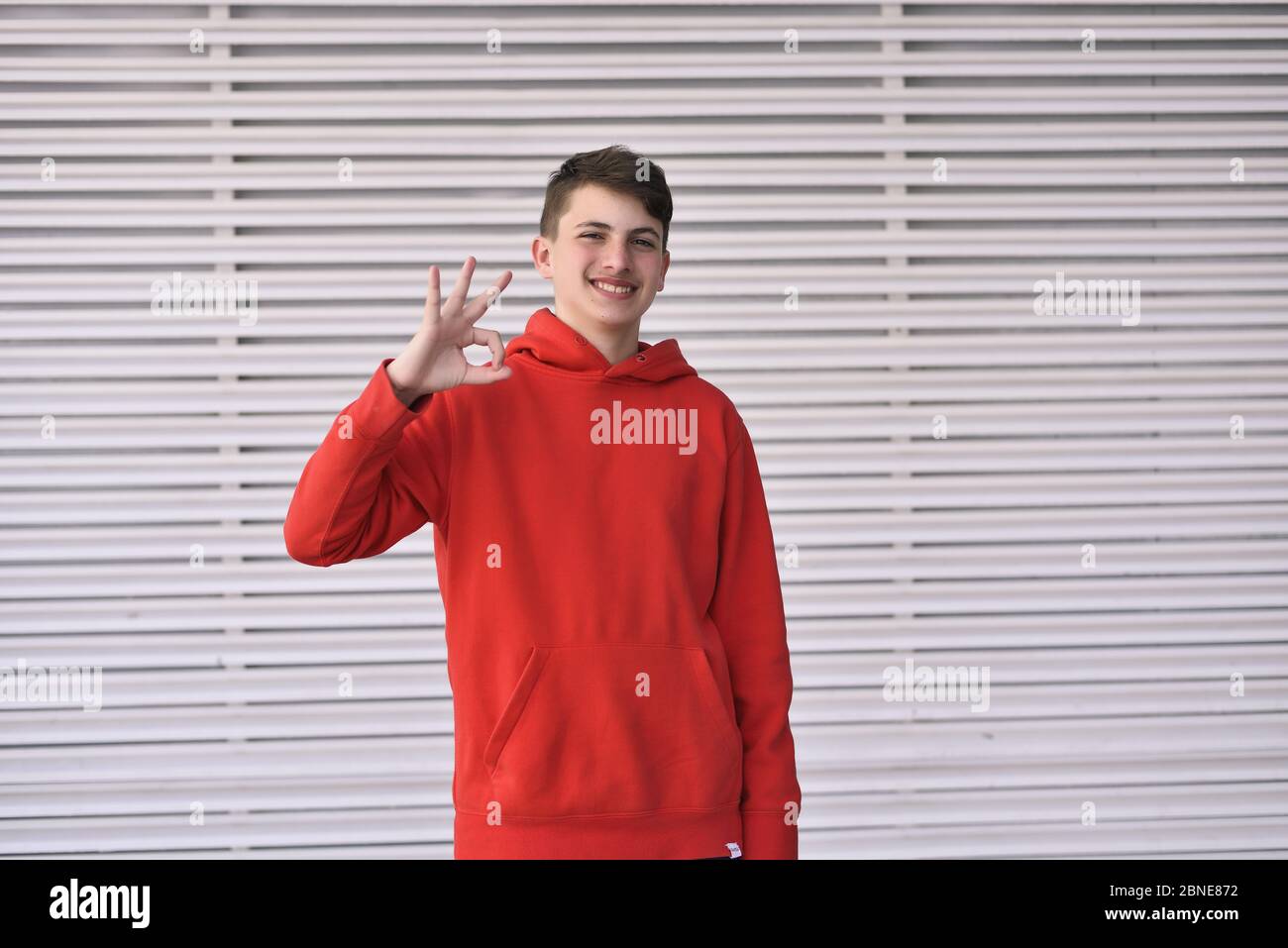 portrait of smiley teenager. dressing in a red shirt Stock Photo - Alamy