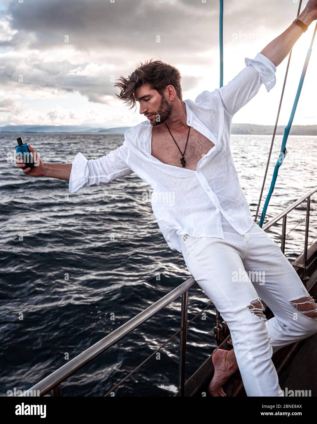 Bearded man holding perfume hi-res stock photography and images - Alamy