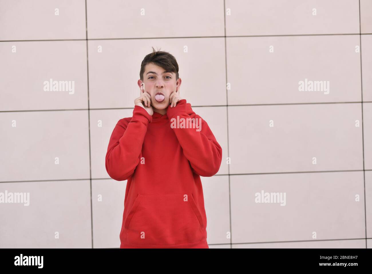 portrait of smiley teenager. dressing in a red shirt Stock Photo - Alamy