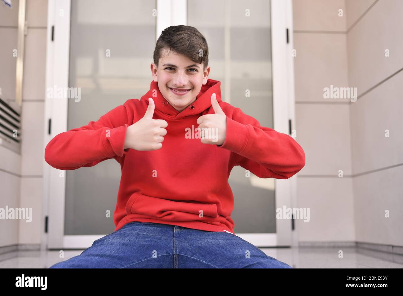 portrait of smiley teenager. dressing in a red shirt Stock Photo - Alamy