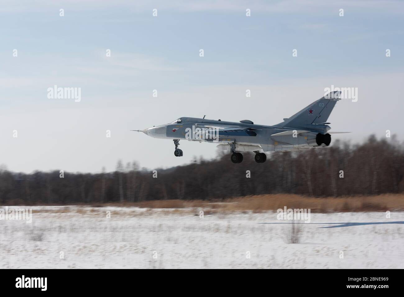 Military jet bomber Su-24 Fencer flying above ground Stock Photo - Alamy