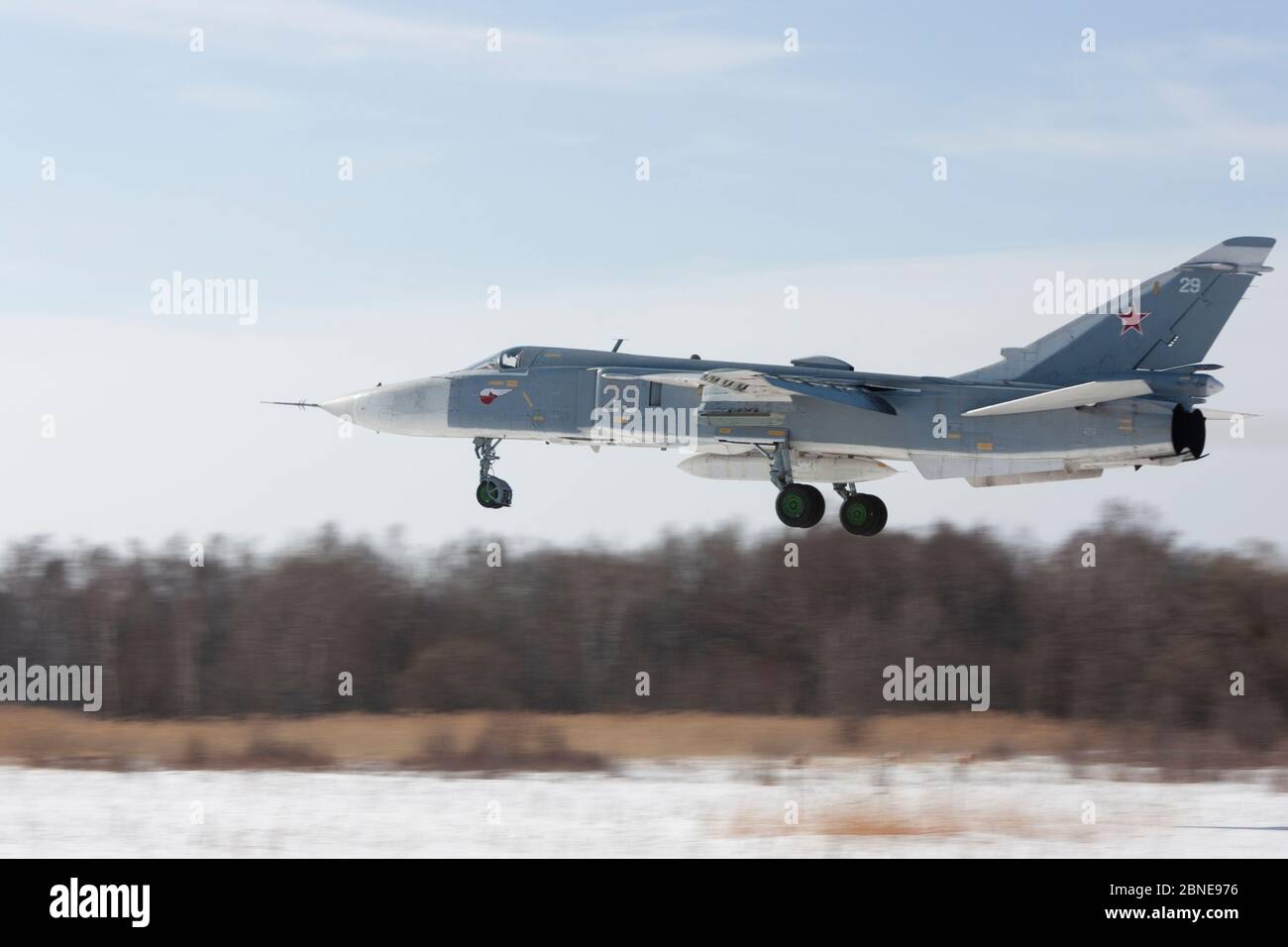 Military jet bomber Su-24 Fencer flying above ground Stock Photo - Alamy