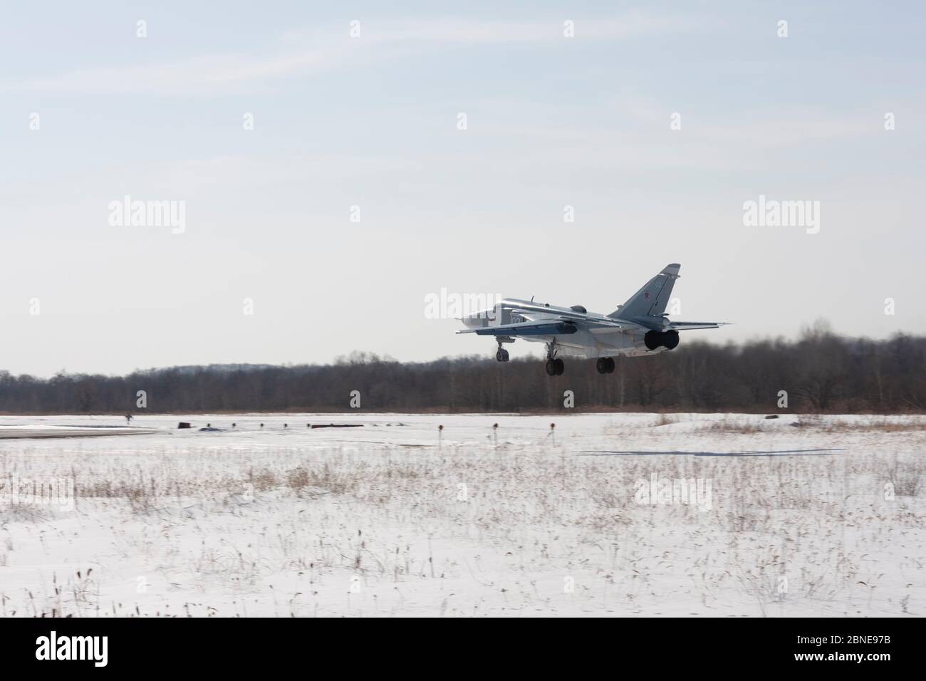 Military jet bomber Su-24 Fencer flying above ground Stock Photo - Alamy