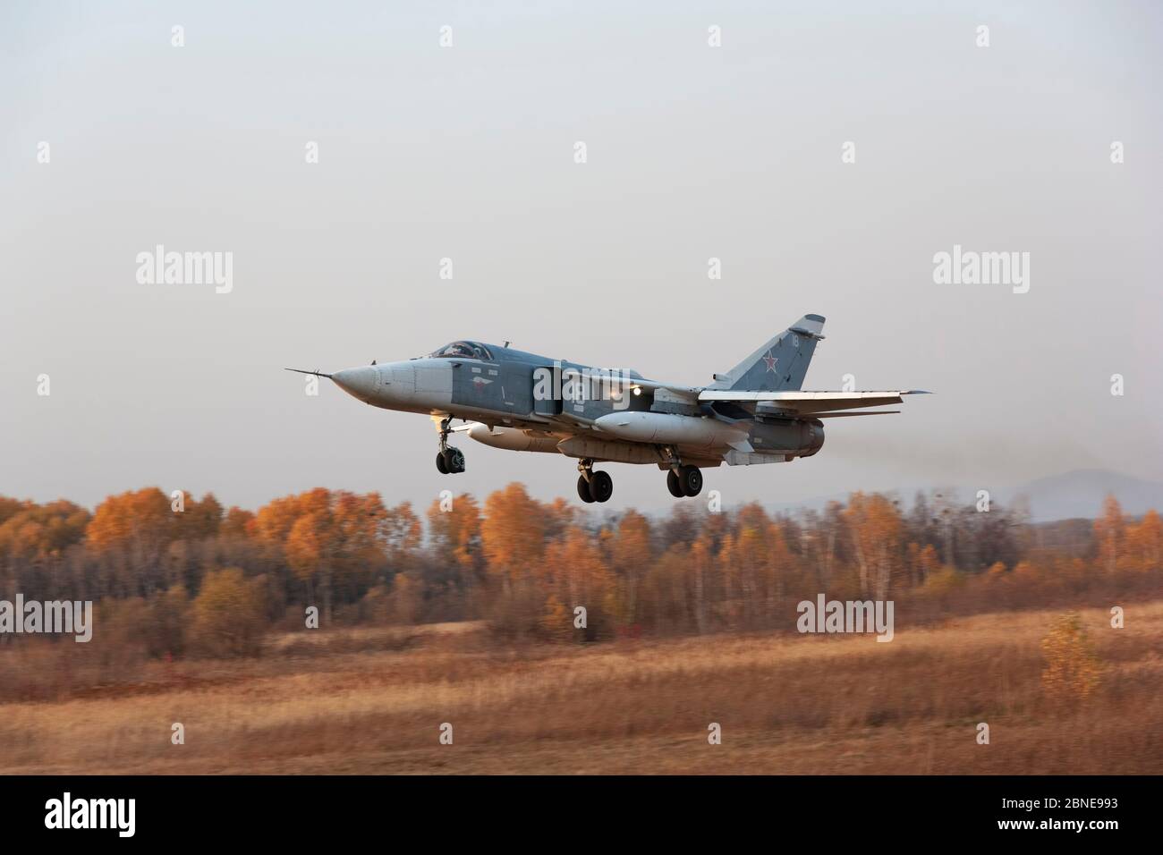 Military jet bomber Su-24 Fencer flying above ground Stock Photo - Alamy