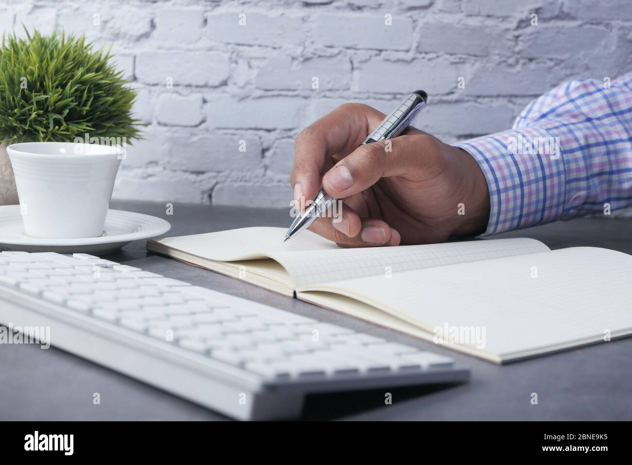 Close up of person hand writing on notepad Stock Photo - Alamy