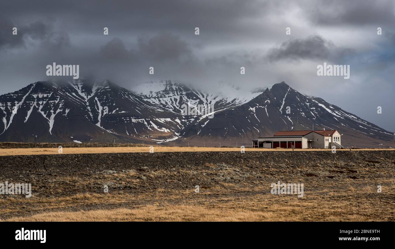 Warehouse in the countryside of Iceland with snowy mountains in spring ...