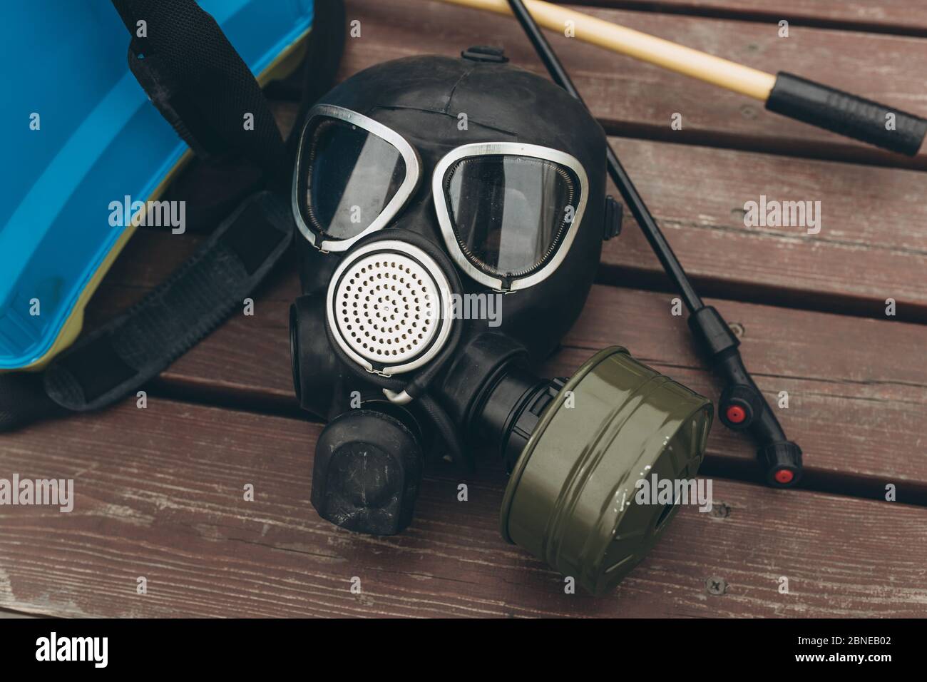 A protective mask and knapsack for disinfection lie on a bench in the ...