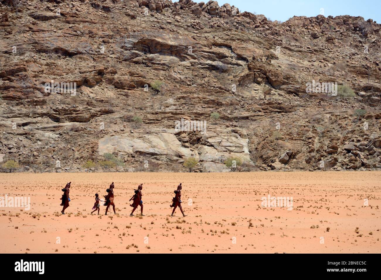 Himba women and child walking in Marienfluss Valley, Kaokoland Desert ...