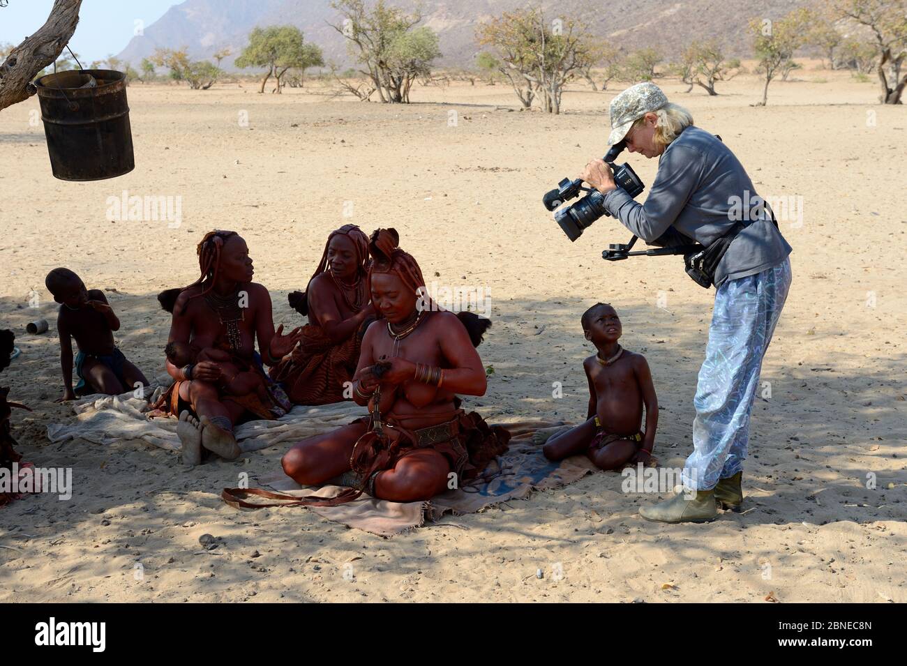 Woman Filming Daily Life Of Himba People Marienfluss Valley Kaokoland