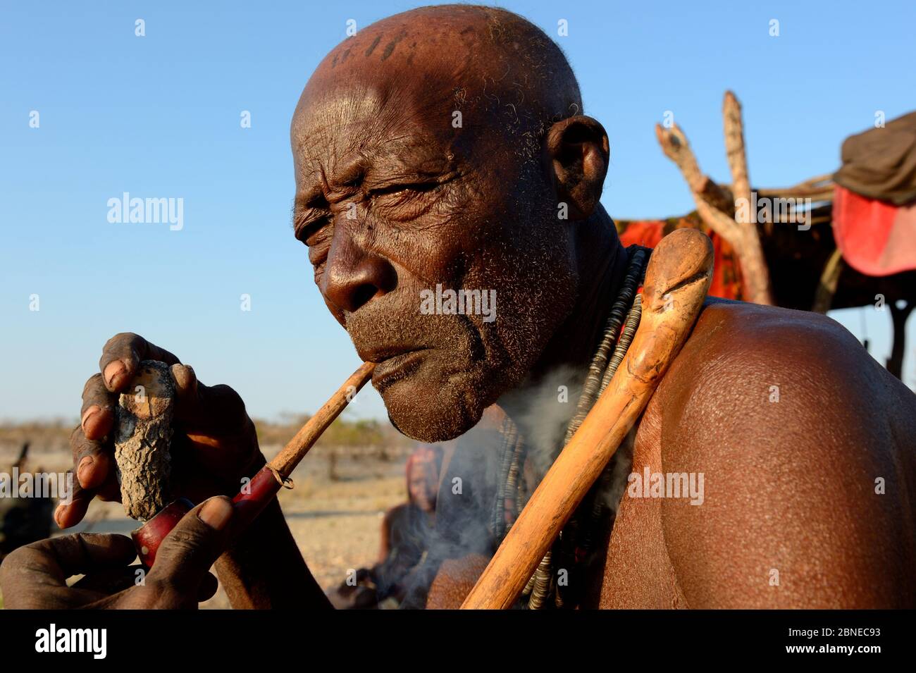 Himba man smoking a pipe, Marienfluss Valley. Kaokoland, Namibia ...
