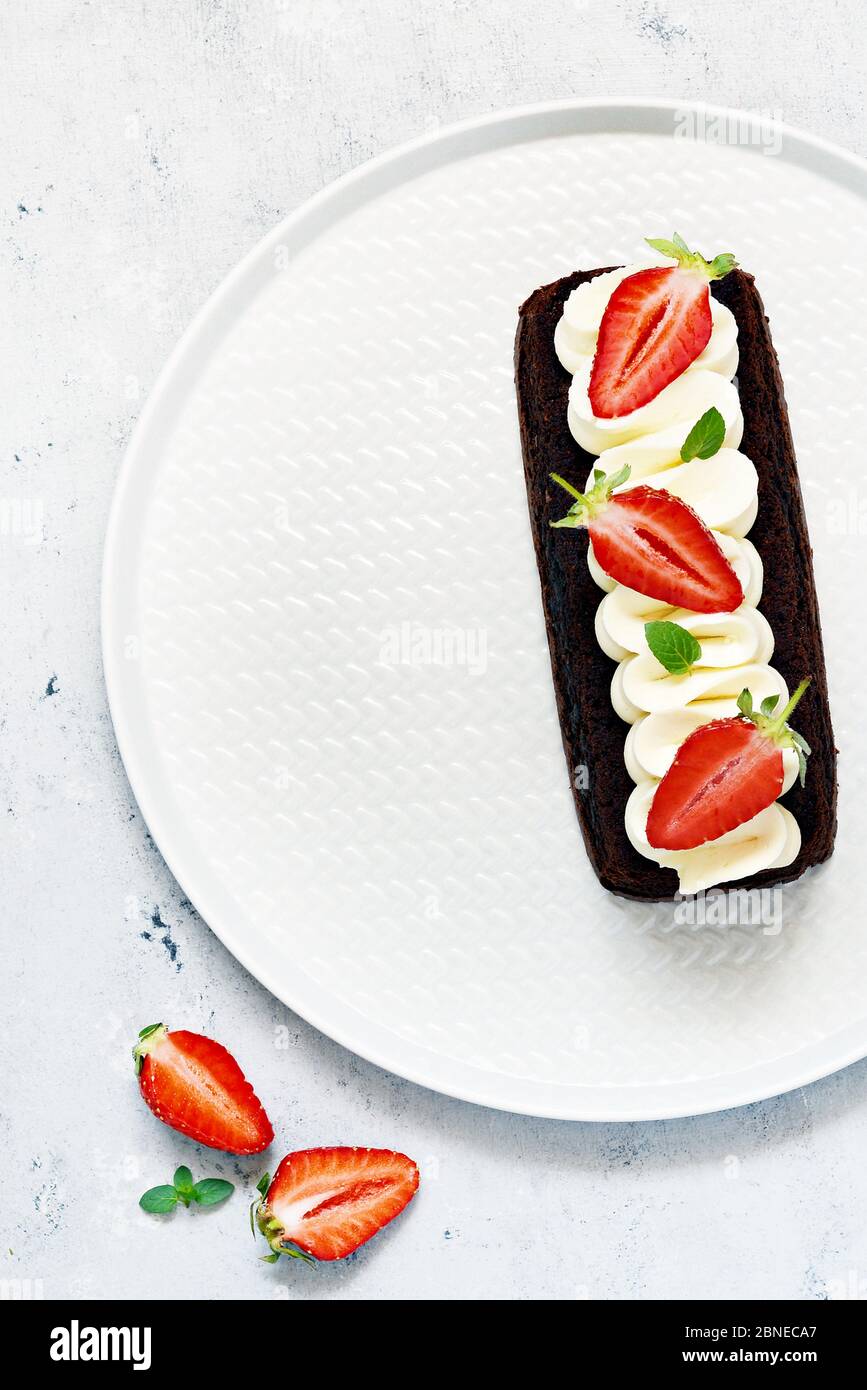 Chocolate brownie with airy vanilla cream and fresh strawberries ...