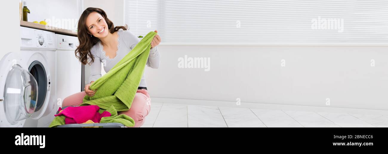 Doing Laundry At Home. Taking Clothes From Washing Machine Stock Photo ...