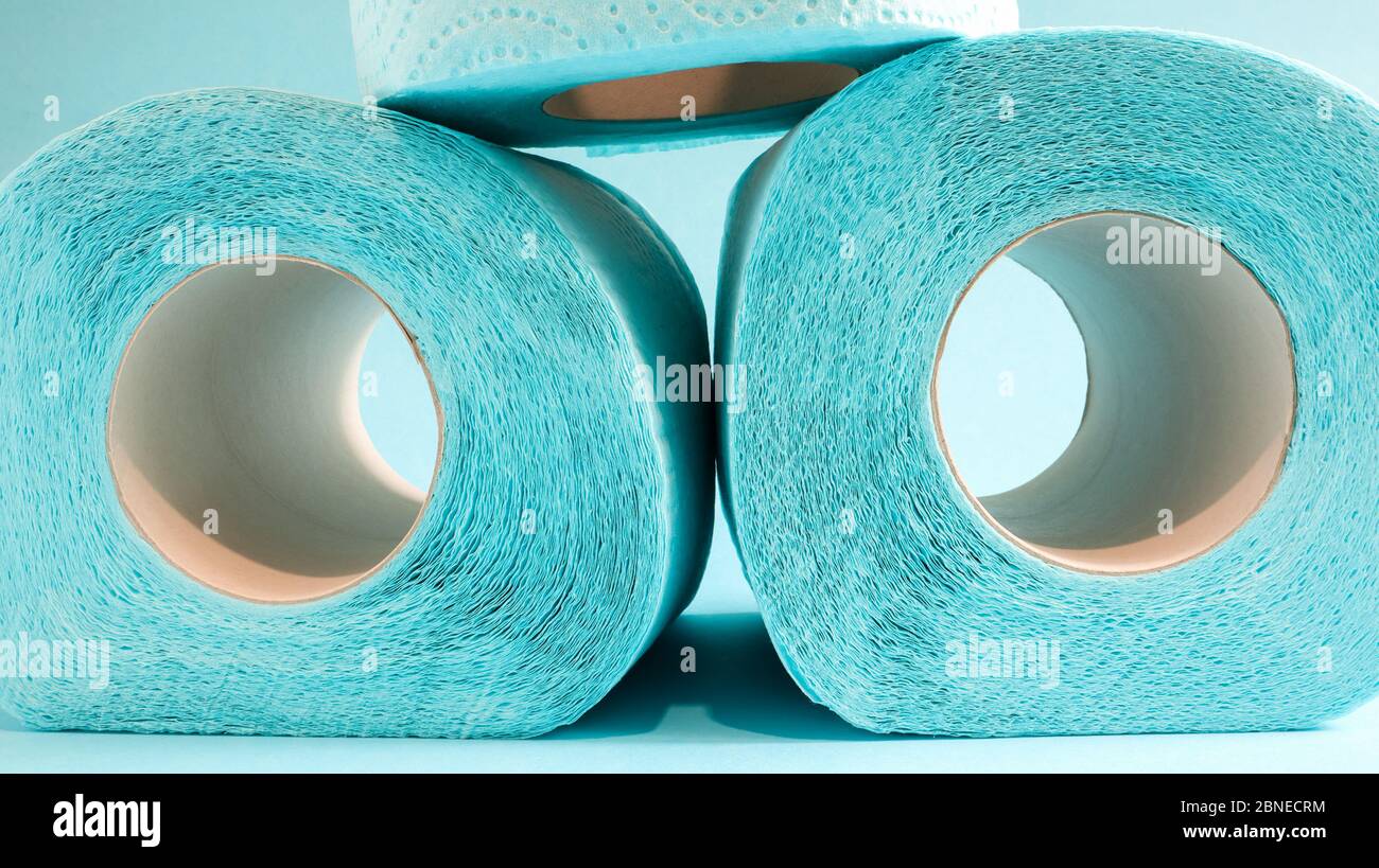 Blue roll of modern toilet paper on a blue background. A paper product ...