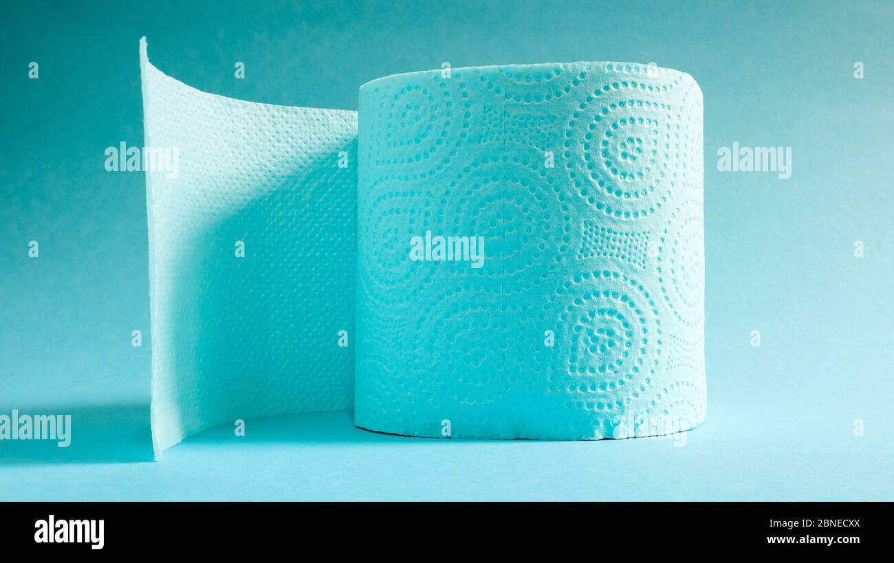 Blue roll of modern toilet paper on a blue background. A paper product ...