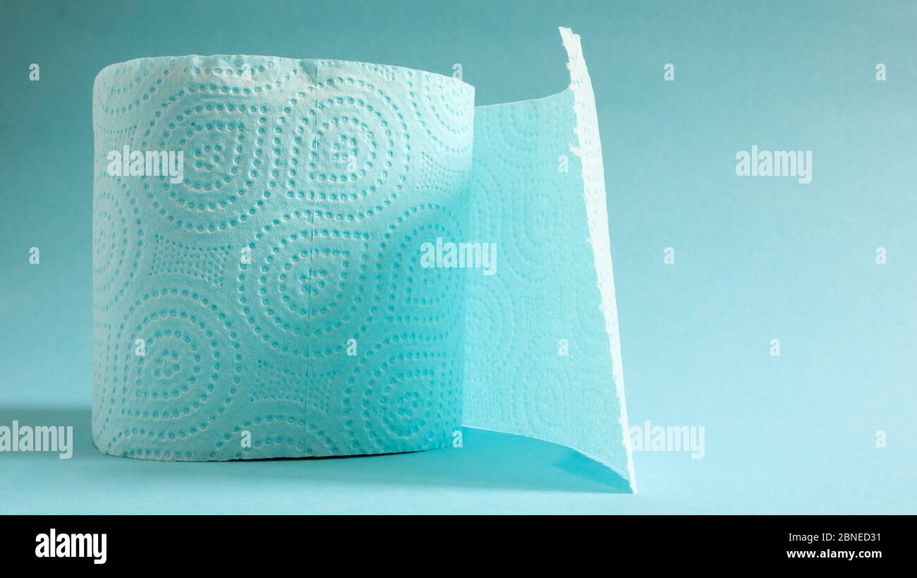 Blue roll of modern toilet paper on a blue background. A paper product ...