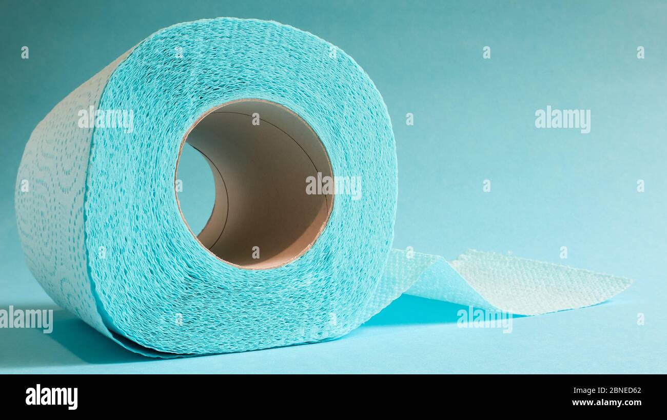 Blue roll of modern toilet paper on a blue background. A paper product ...