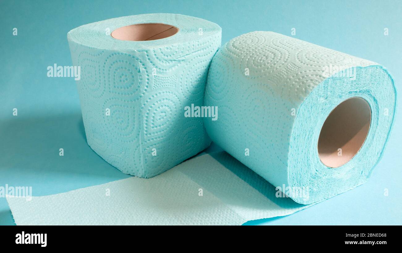 Blue roll of modern toilet paper on a blue background. A paper product ...