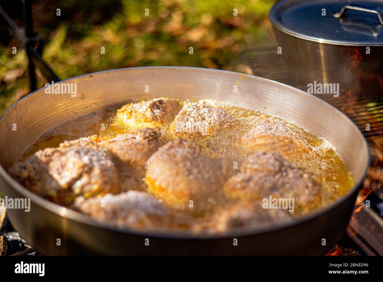 Cooking food over open fire while camping on an adventure Stock Photo ...