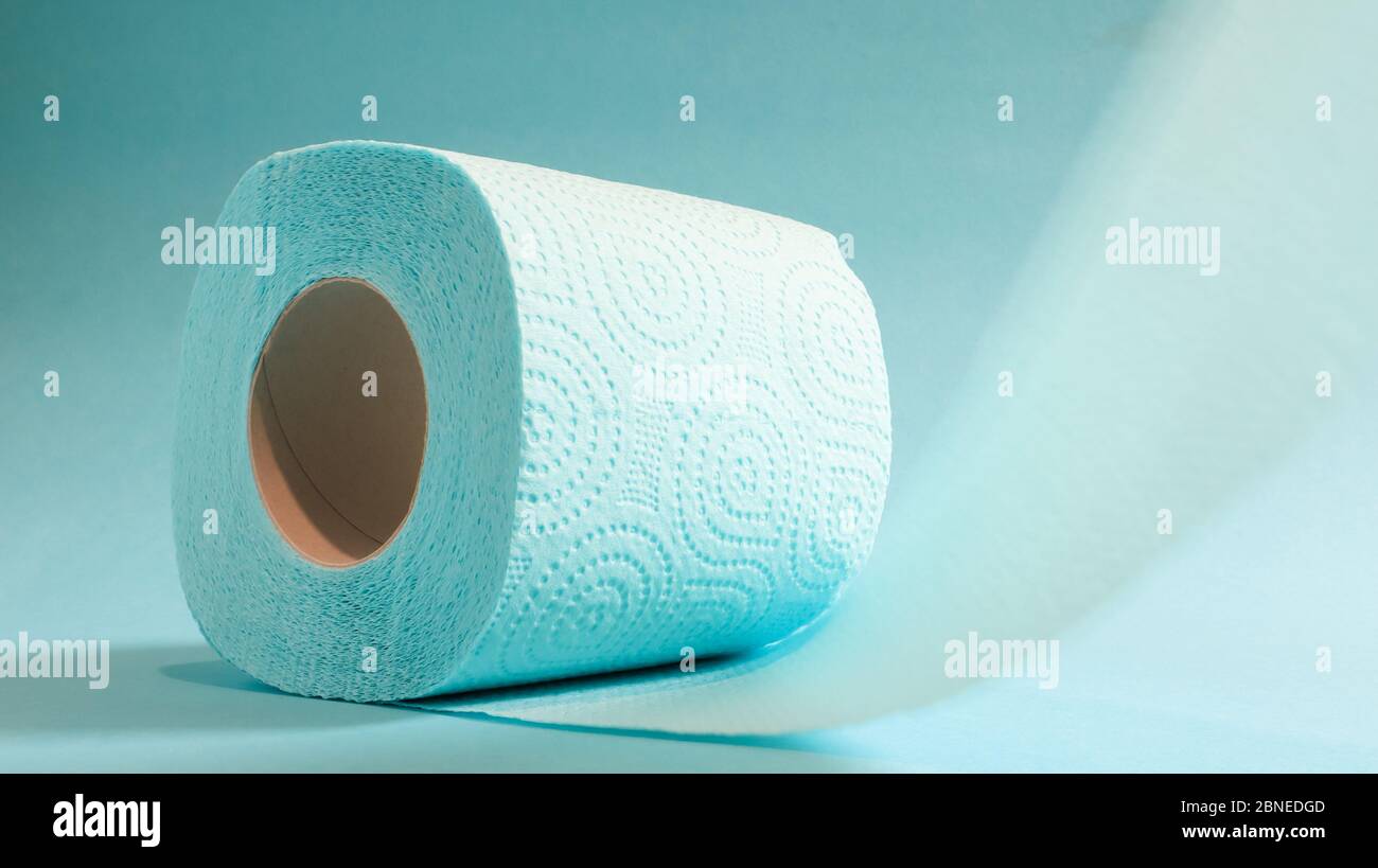 Blue roll of modern toilet paper on a blue background. A paper product ...