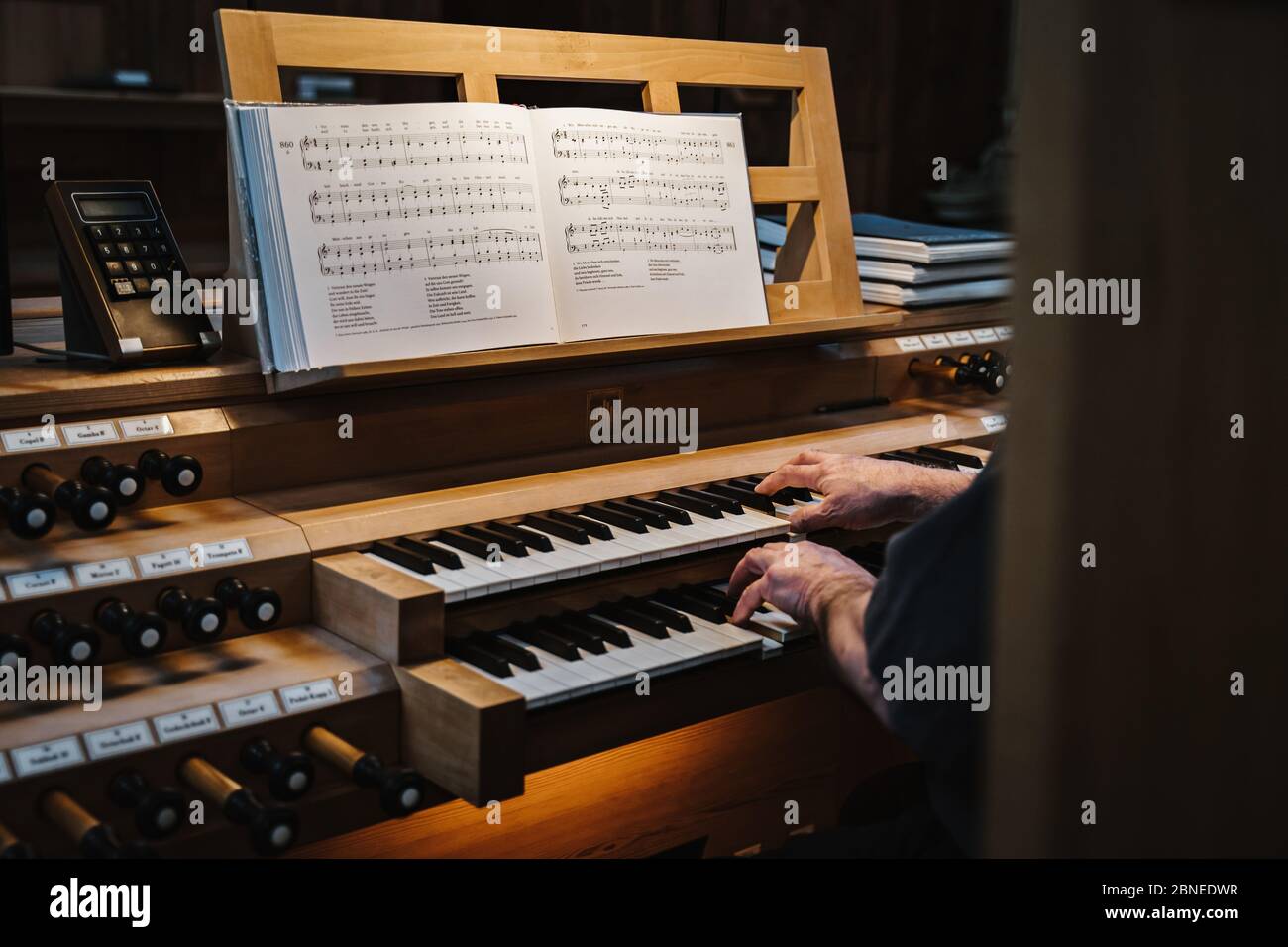 photo of a man playing an organ in a church Stock Photo - Alamy