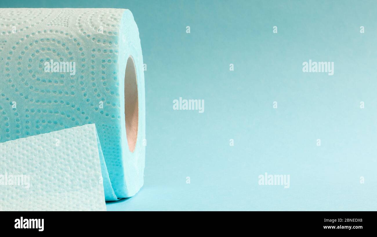 Blue roll of modern toilet paper on a blue background. A paper product ...