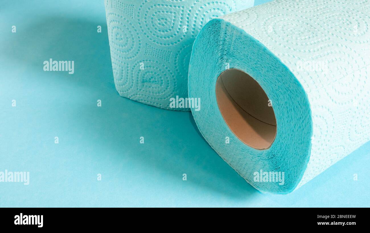 Blue roll of modern toilet paper on a blue background. A paper product ...