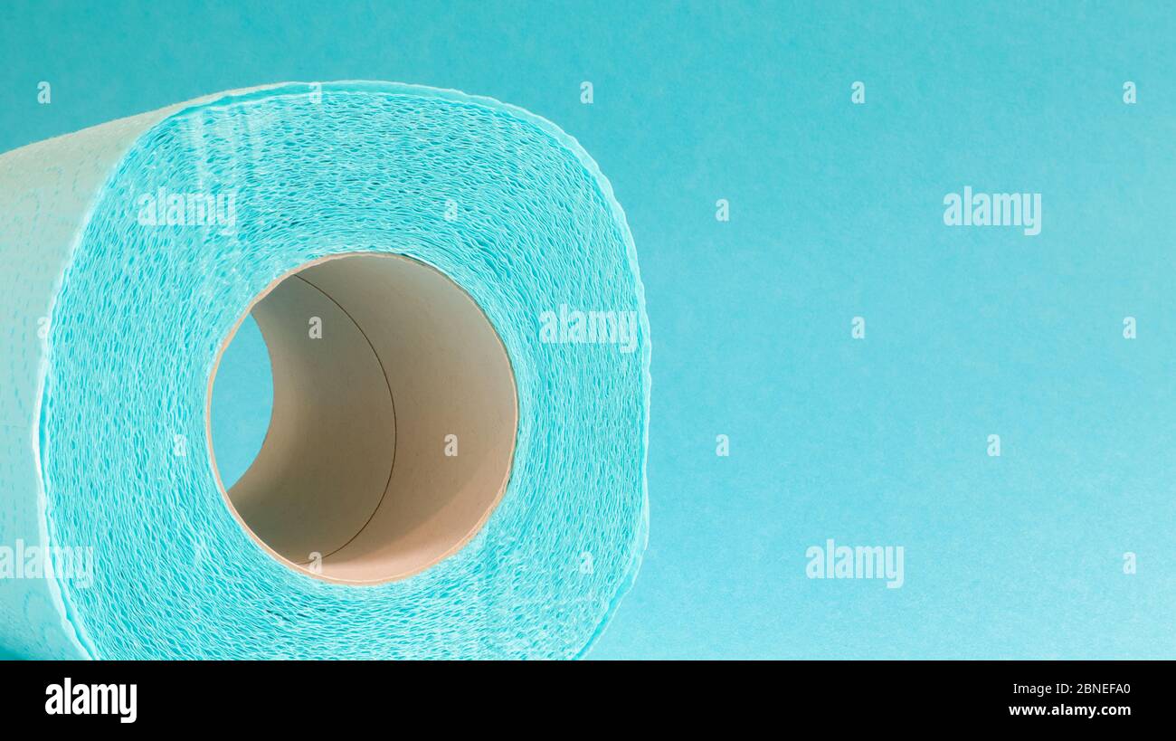 Blue roll of modern toilet paper on a blue background. A paper product ...