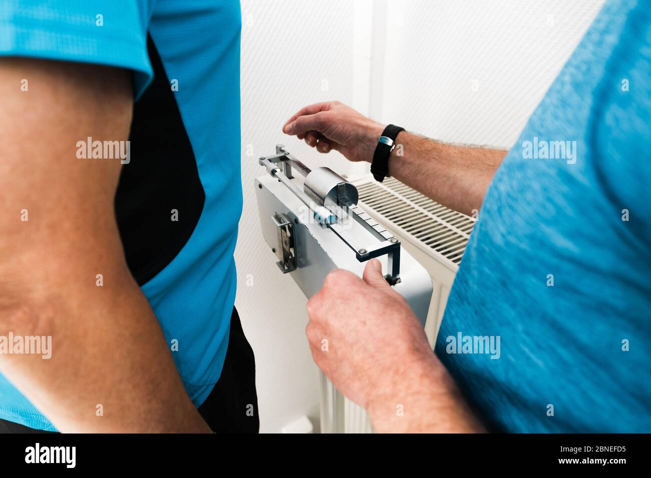 photo of a man measuring his weight on the scale Stock Photo - Alamy