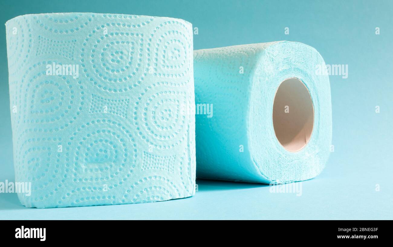 Blue roll of modern toilet paper on a blue background. A paper product ...