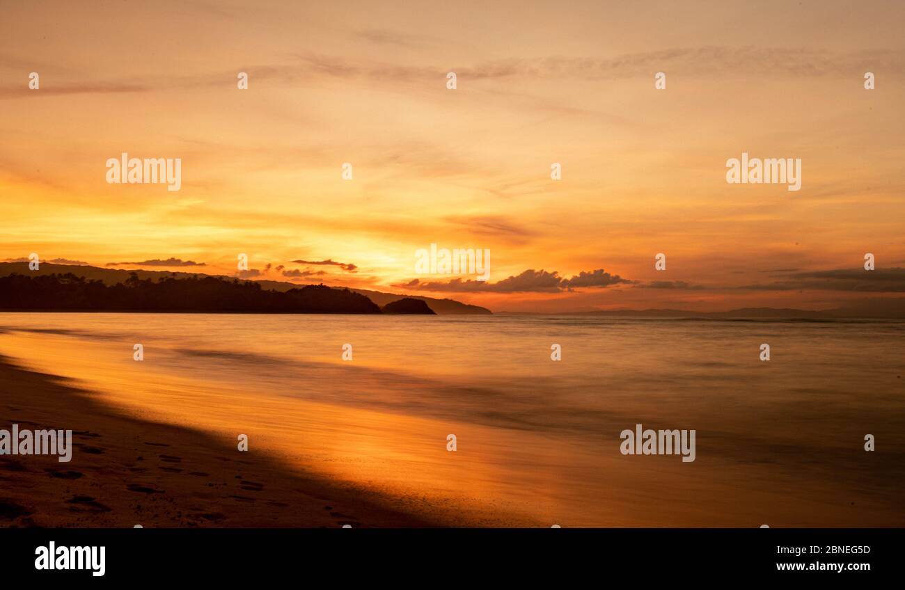 Mesmerizing scenery of a beach and a sea during the sunset Stock Photo ...