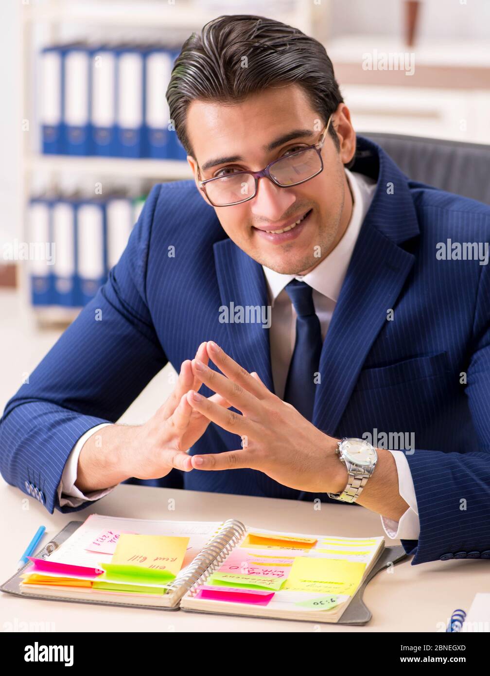 The young handsome employee planning his work activity Stock Photo - Alamy