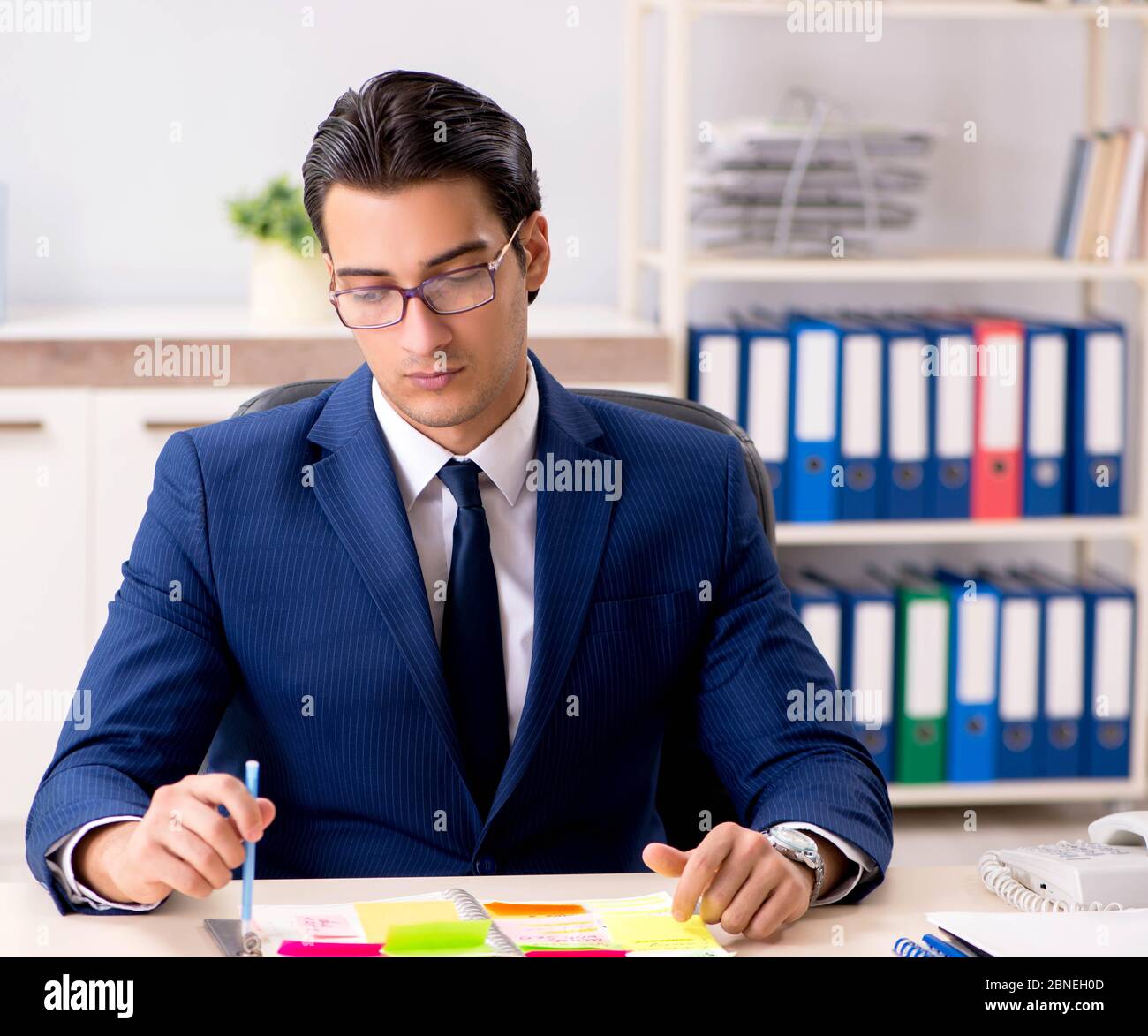 The young handsome employee planning his work activity Stock Photo - Alamy