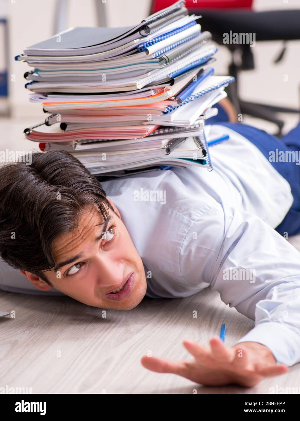 The extremely busy employee working in the office Stock Photo - Alamy