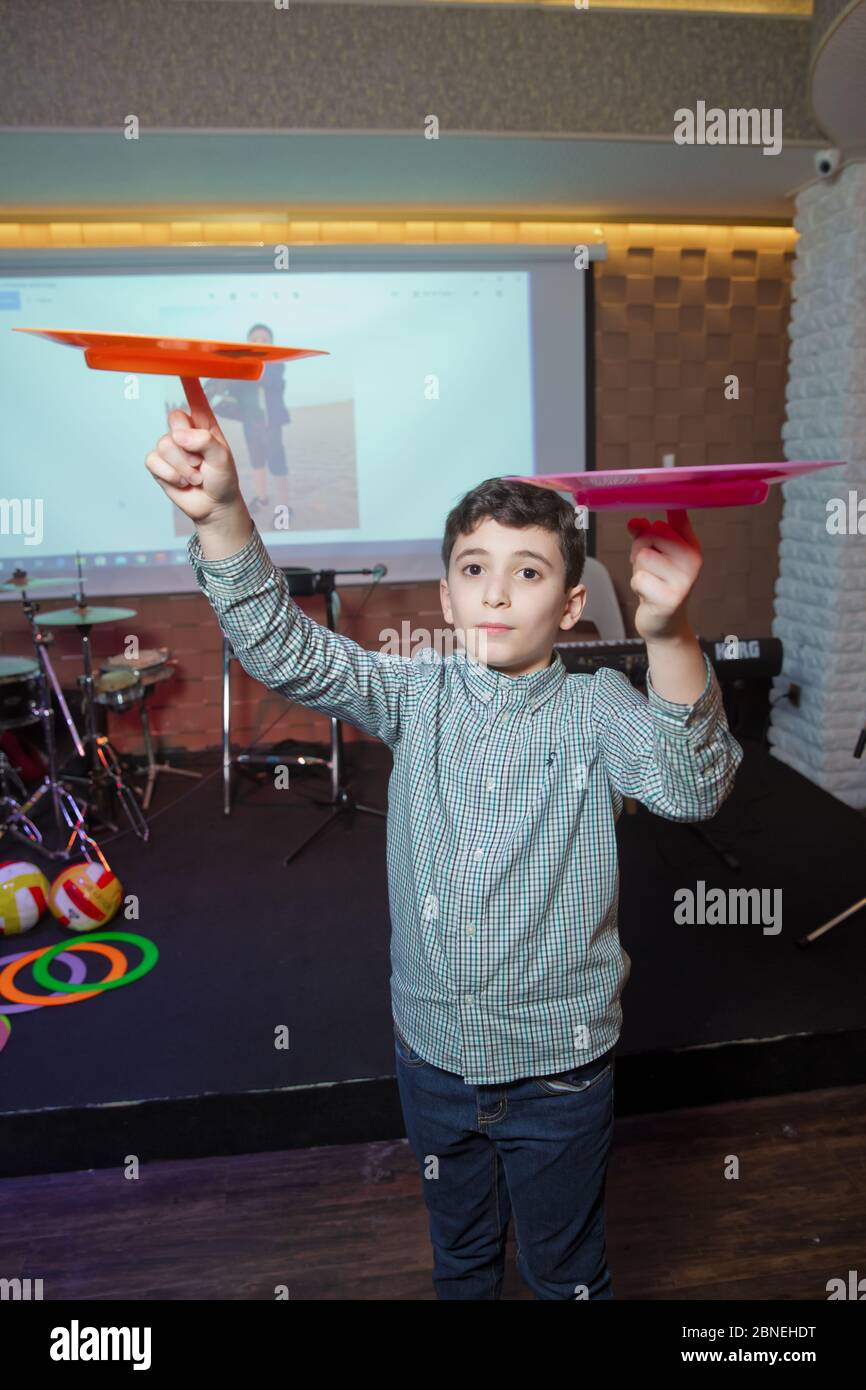 Child spinning white, blue, plates . Fun with Spinning Plates ...