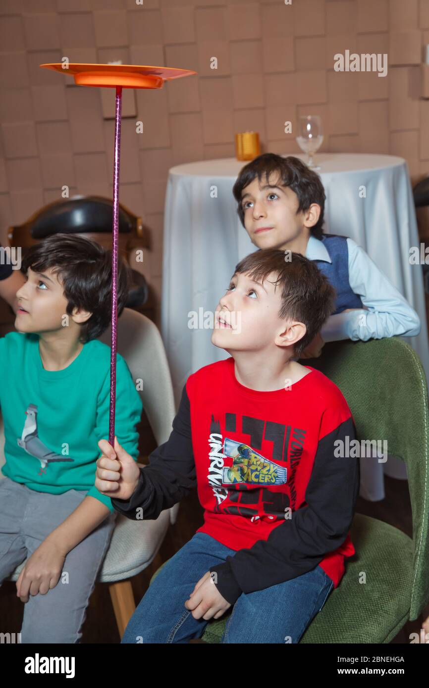 Child spinning white, blue, plates . Fun with Spinning Plates ...