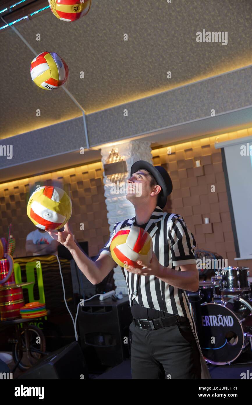 Man juggling blue balls . Stylish Man and boy with black and white ...