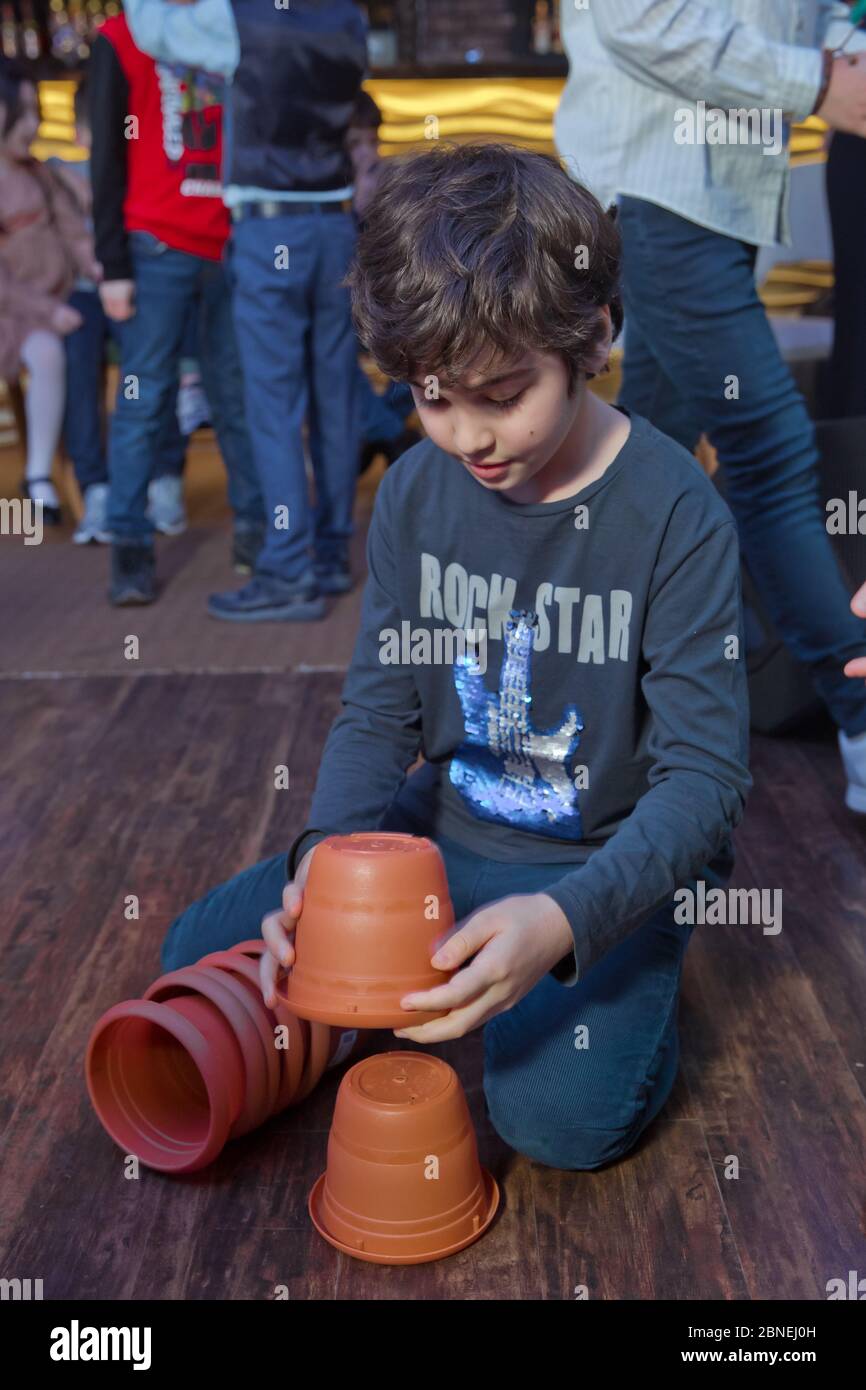 children play a race to stack a bowl on top of each other. Kids Playing ...