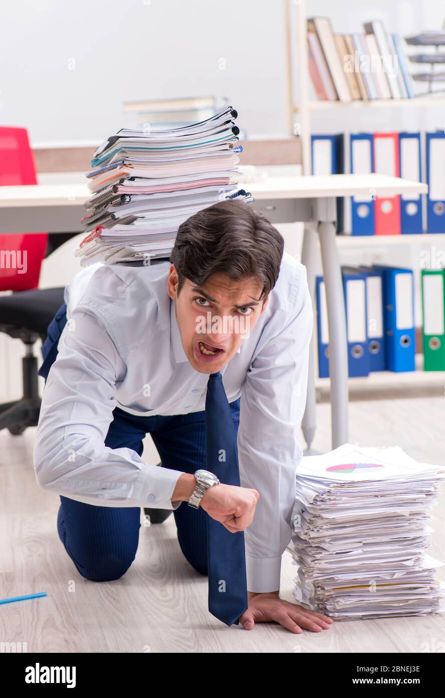 The extremely busy employee working in the office Stock Photo - Alamy