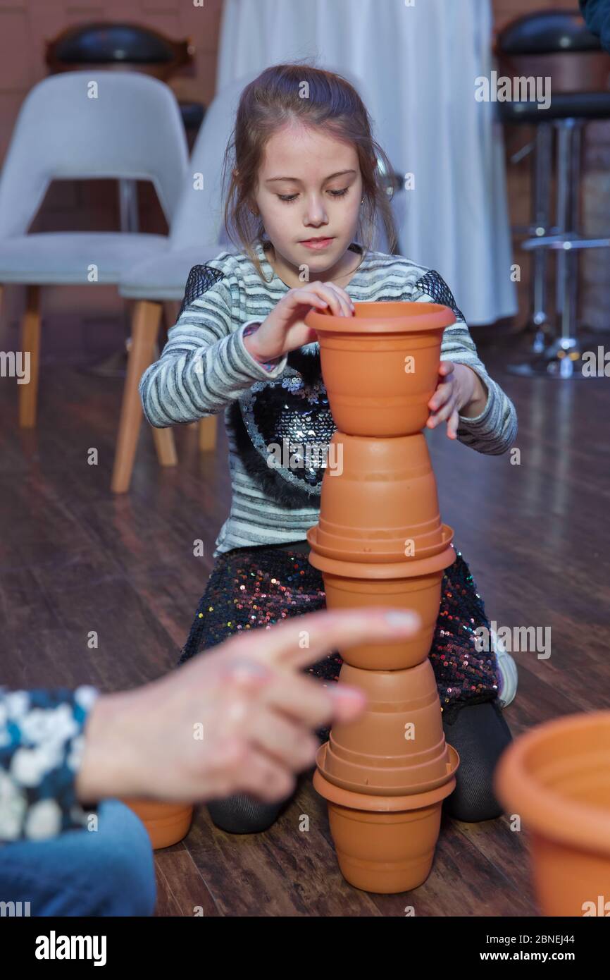 children play a race to stack a bowl on top of each other. Kids Playing ...